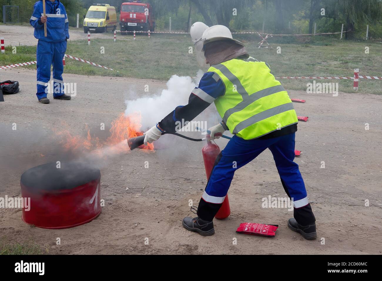 Firefighter on training. Fireman using use a fire extinguisher on a ...