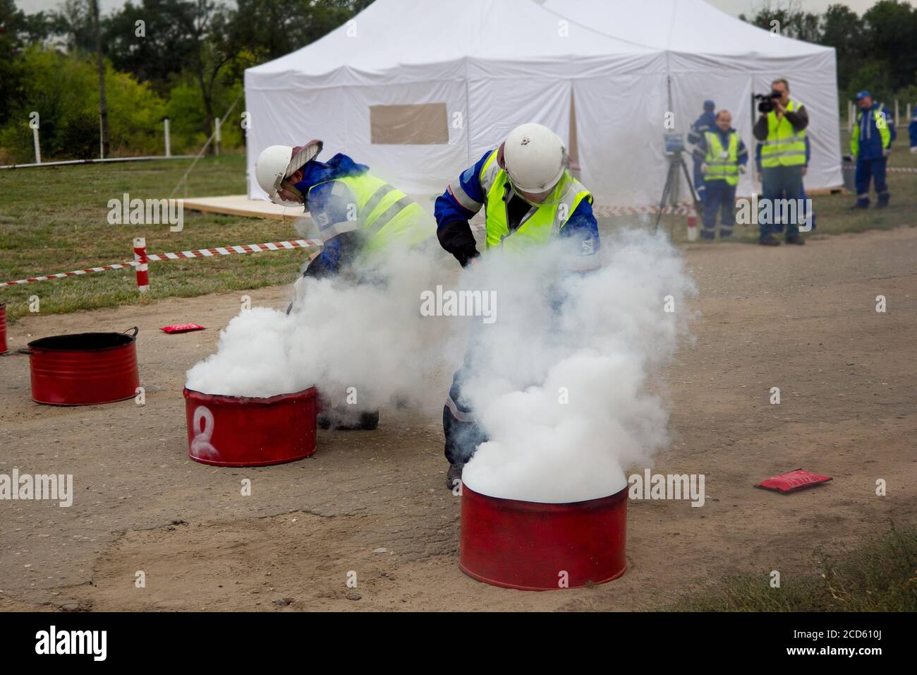 Firefighters on training. Firemen using use a fire extinguisher on a ...