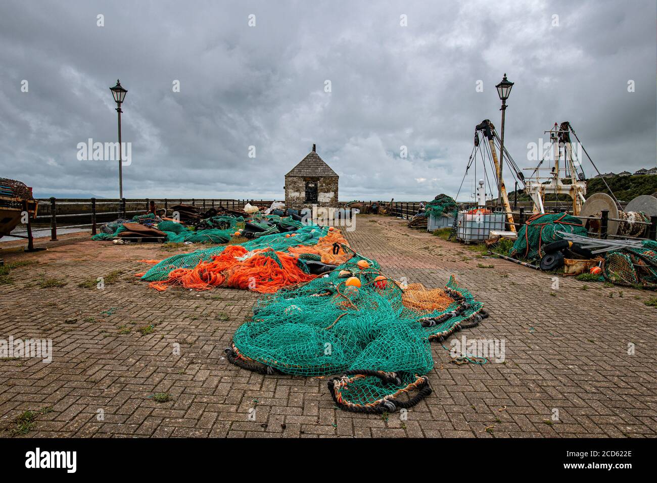Fishing nets piled on the quayside at Maryport Stock Photo - Alamy