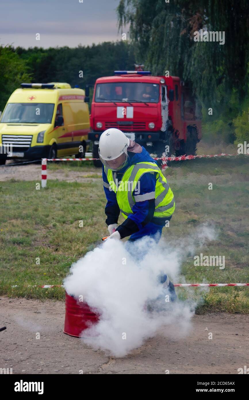 Firefighter on training. Fireman using use a fire extinguisher on a ...