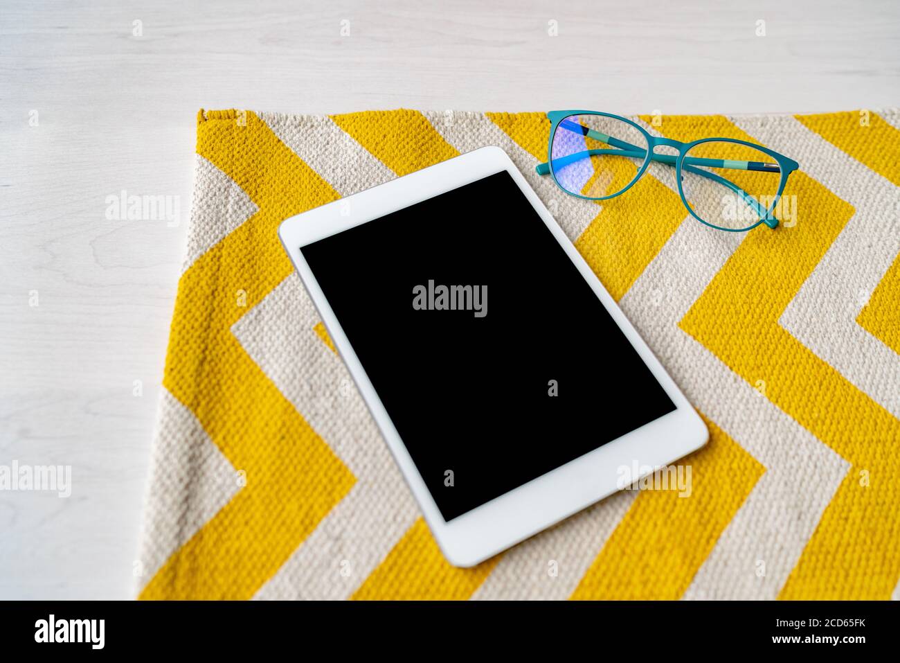 Tablet on dining table with reading glasses - blue light protection ...