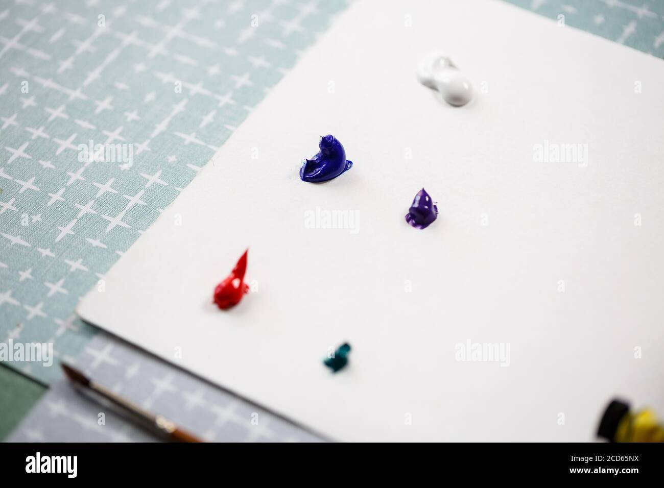 Paints squeezed out of a tube on a white sheet. They are for drawing on ...