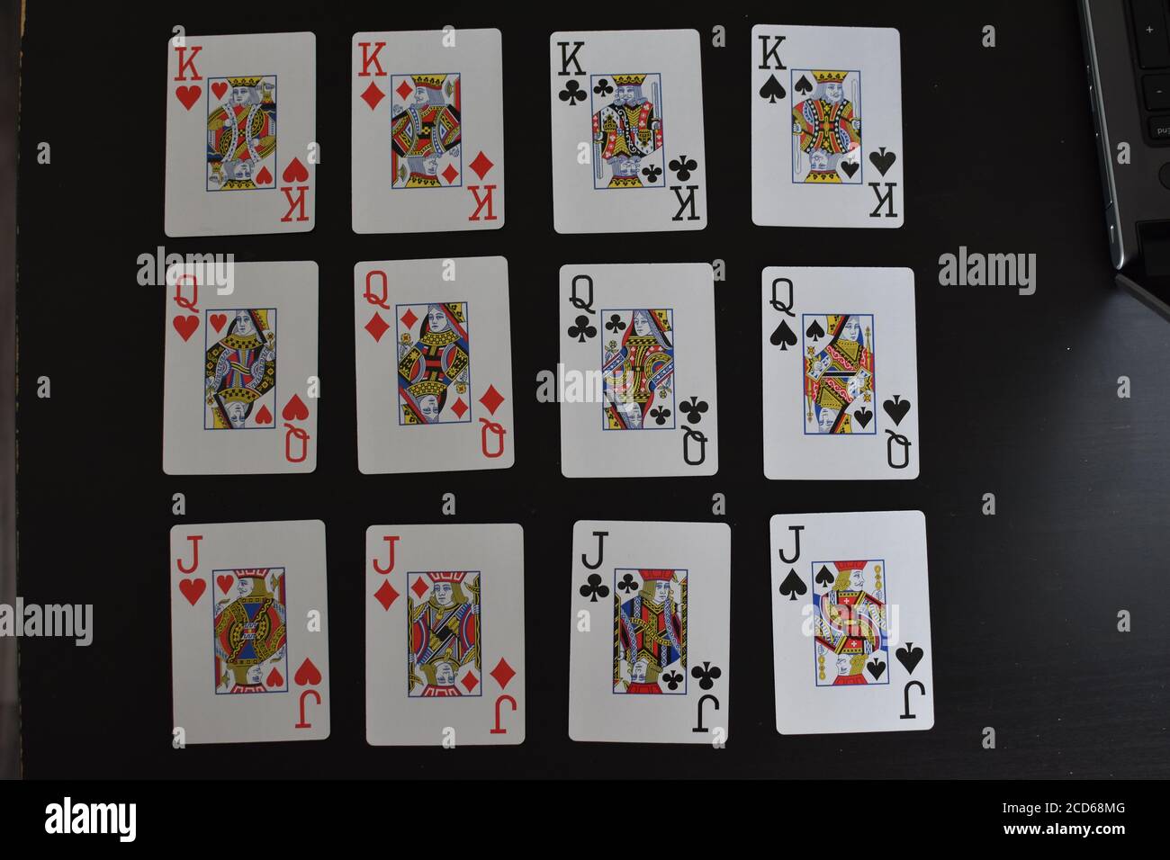 Playing cards arranged on black background Stock Photo - Alamy