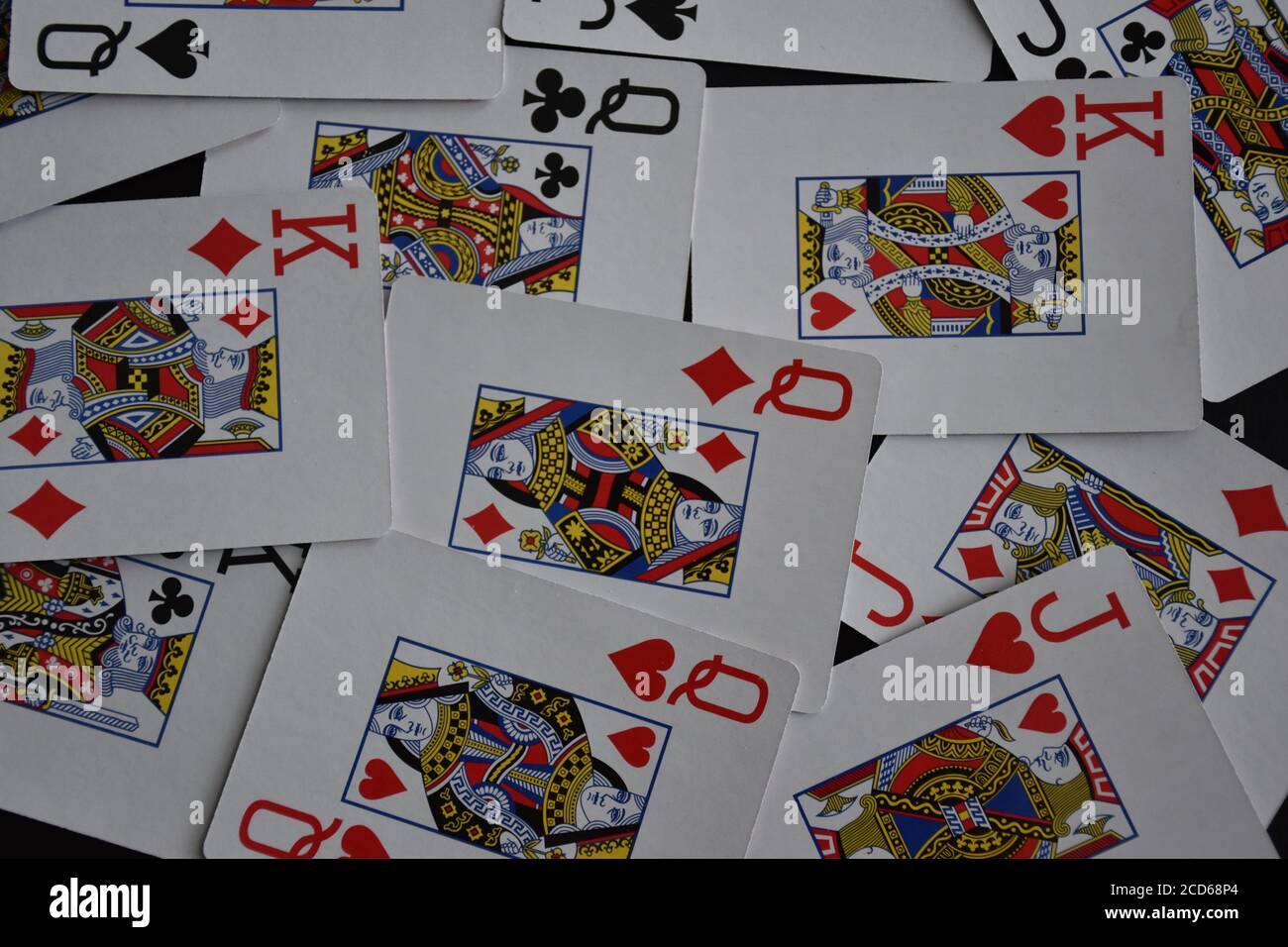 Playing cards arranged on black background Stock Photo - Alamy