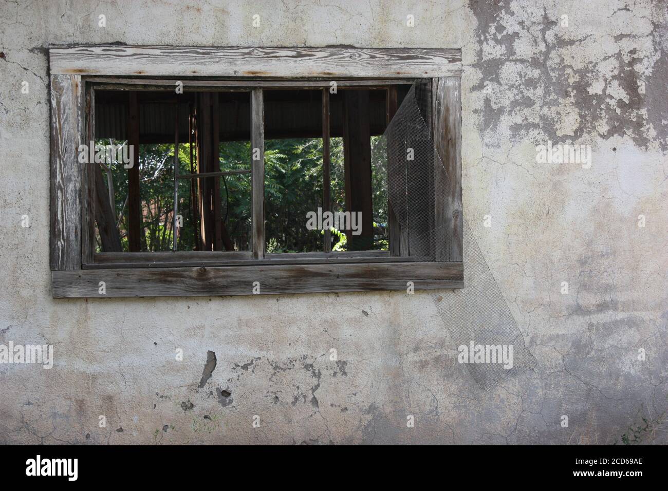 Eerie worn, wood windows of an abandoned old adobe building in a ghost ...