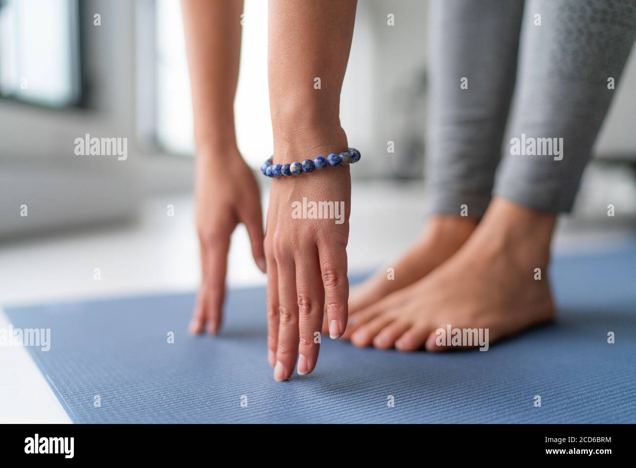 Yoga at home exercise in living room house - woman on fitness mat ...