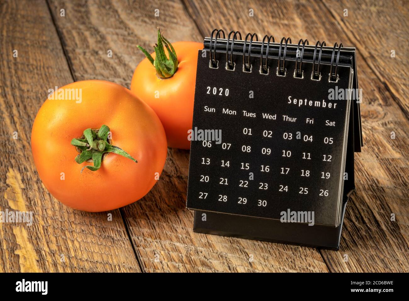 September 2020 - spiral desktop calendar on a rustic wooden table with ...