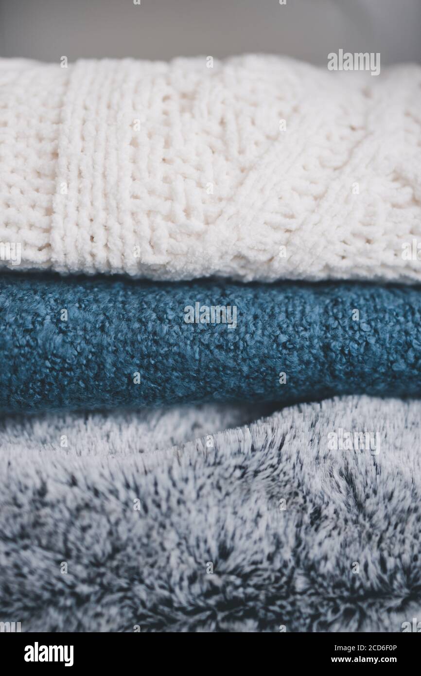 winter lifestyle and home decor concept, soft and fluffy blankets and ...