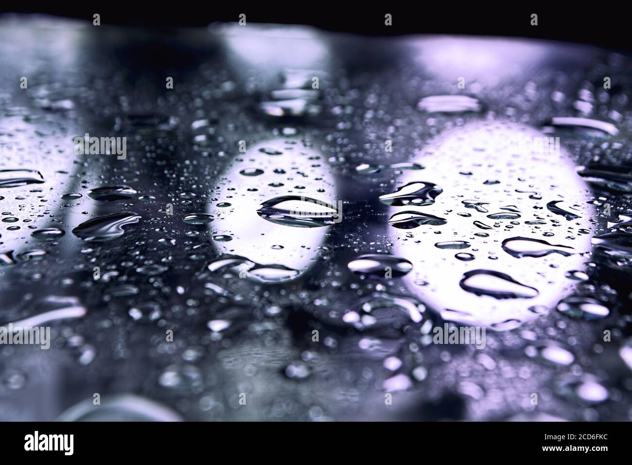 Closeup of waterdrops on a surface under the lights - perfect for ...