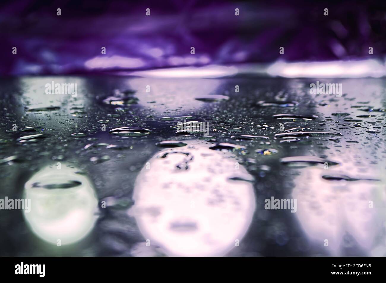 Closeup of waterdrops on a surface under the lights - perfect for ...