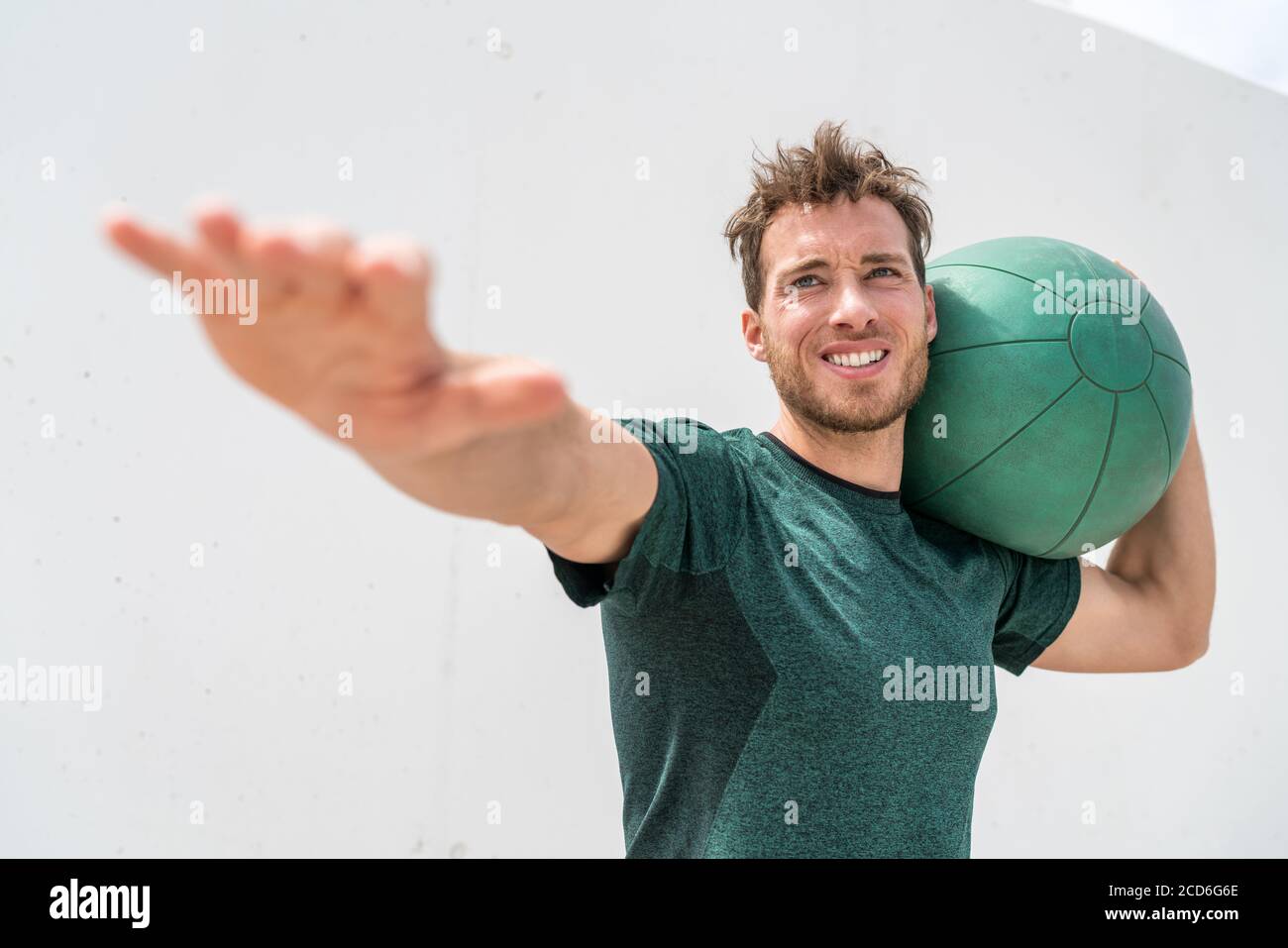 Medicine ball heavy weighted ball workout man training in outdoor gym ...