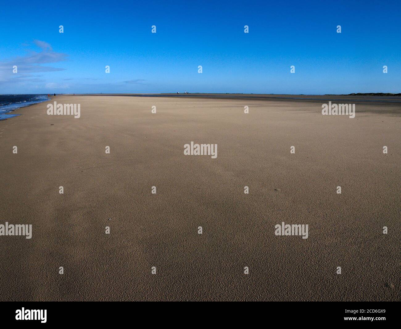 Wide shot of a beach scenery with beautiful blue skies Stock Photo - Alamy