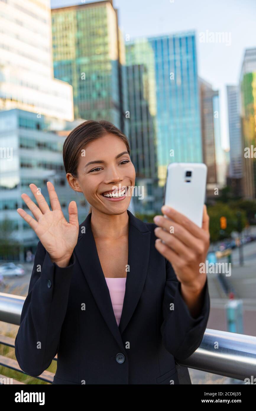 People on video call saying hello waving at camera. Asian woman video ...