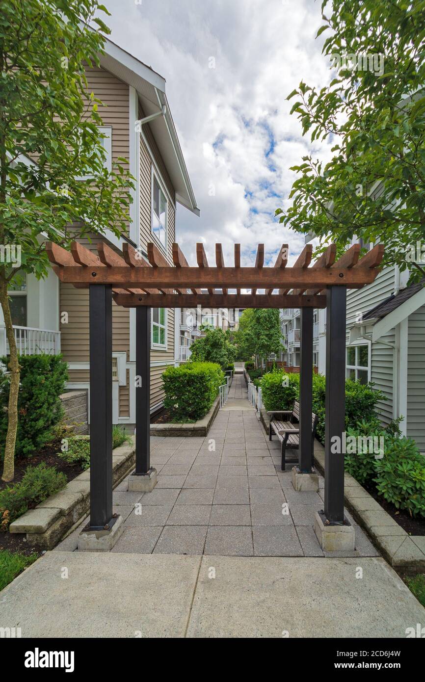 Pathway in residential area between two rows of townhouses Stock Photo ...