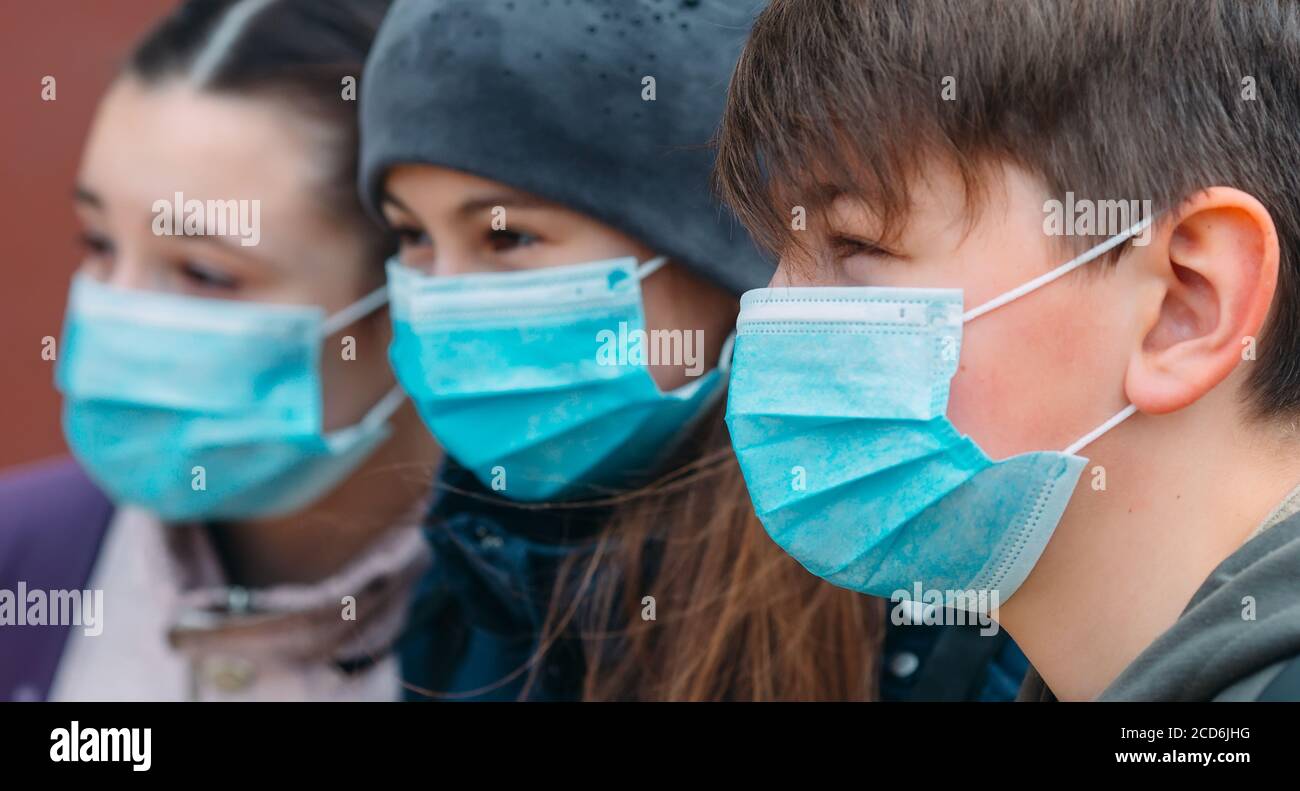 School-age children in medical masks. portrait of school children Stock ...