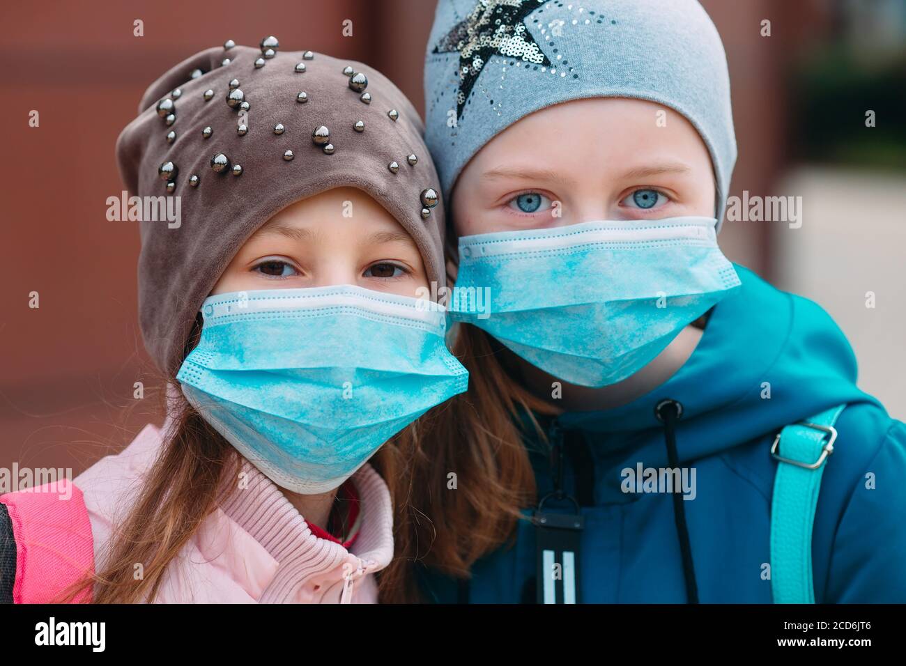 School-age children in medical masks. portrait of school children Stock ...