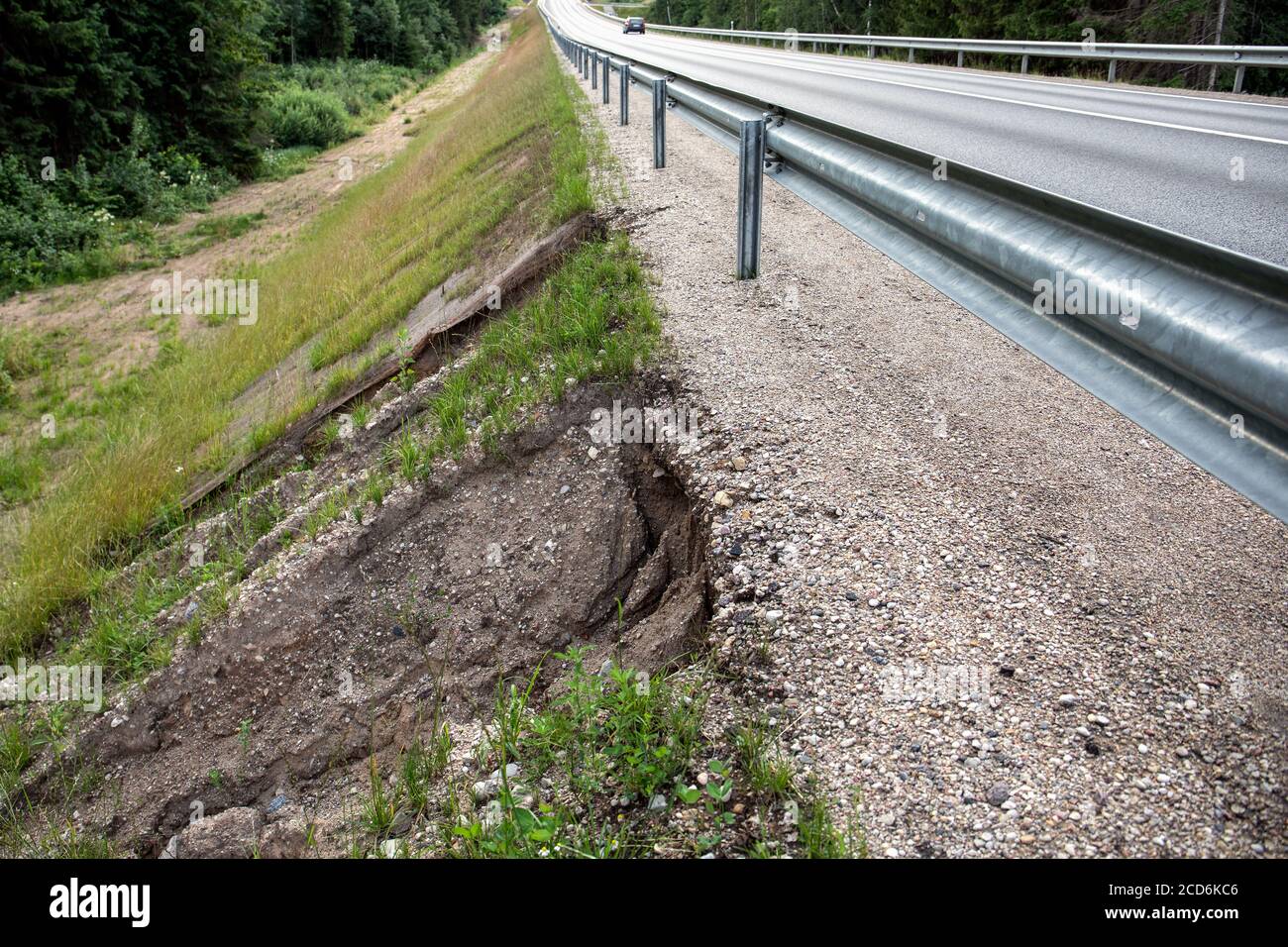 Rainwater washes the road. Dangerous situation, road safety and traffic ...