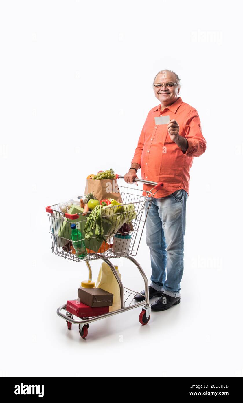 Indian old man with shopping cart or trolly full of vegetables, fruits ...
