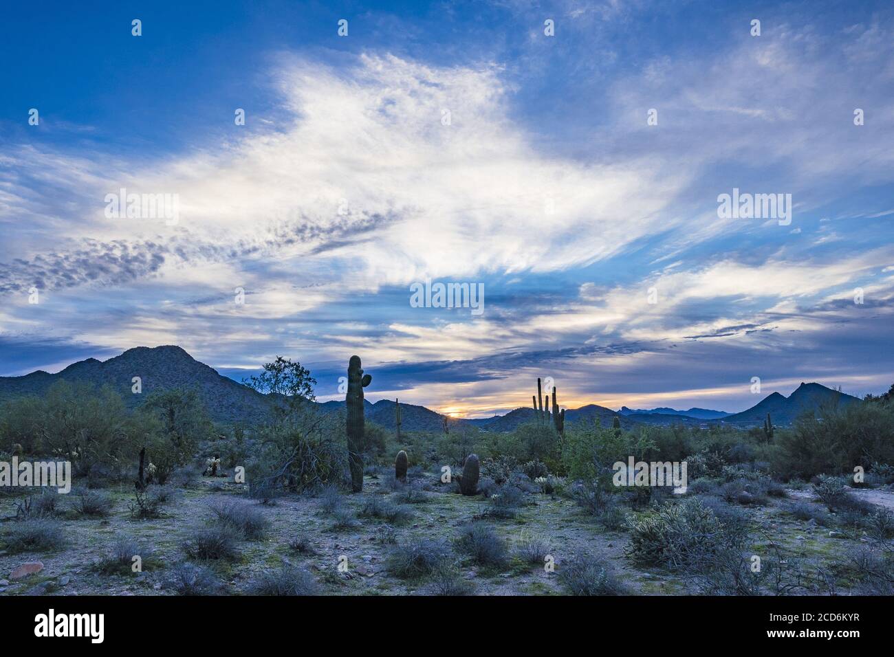The sun is lighting up the desert terrain Stock Photo - Alamy