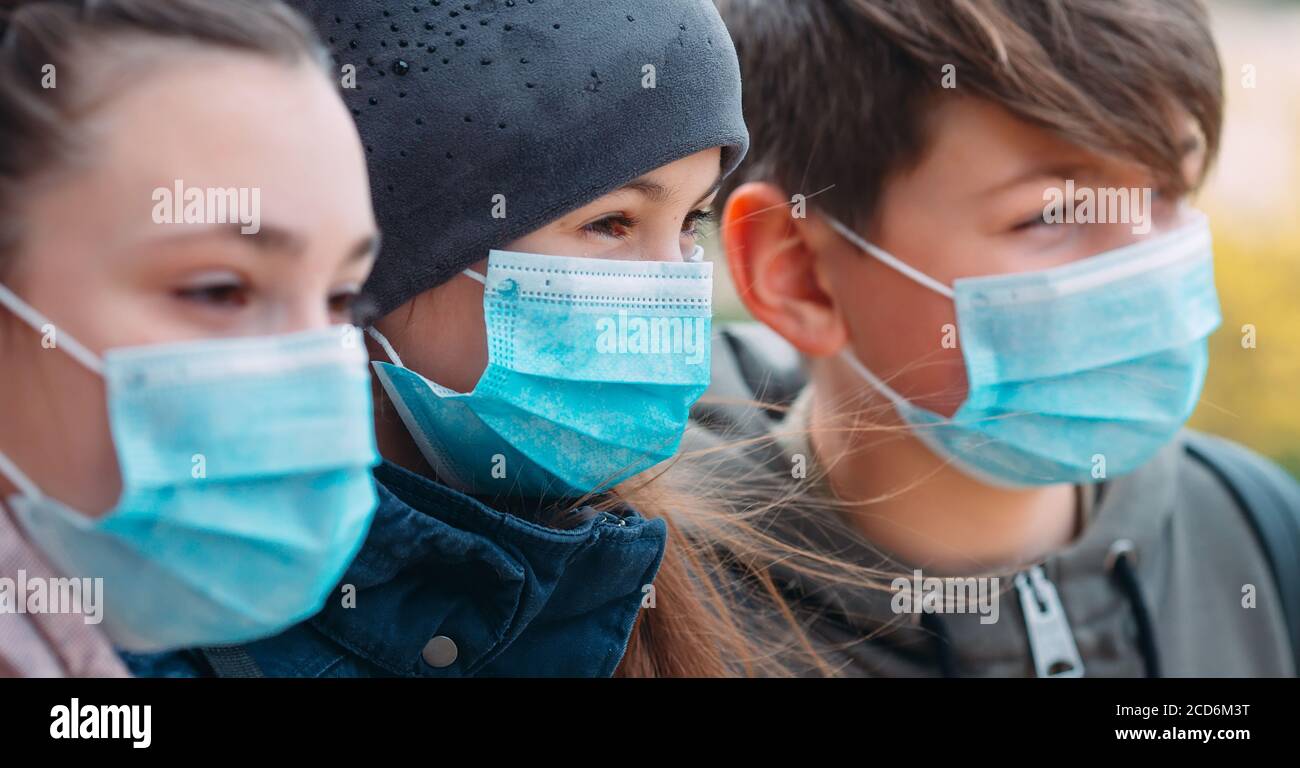 School-age children in medical masks. portrait of school children Stock ...