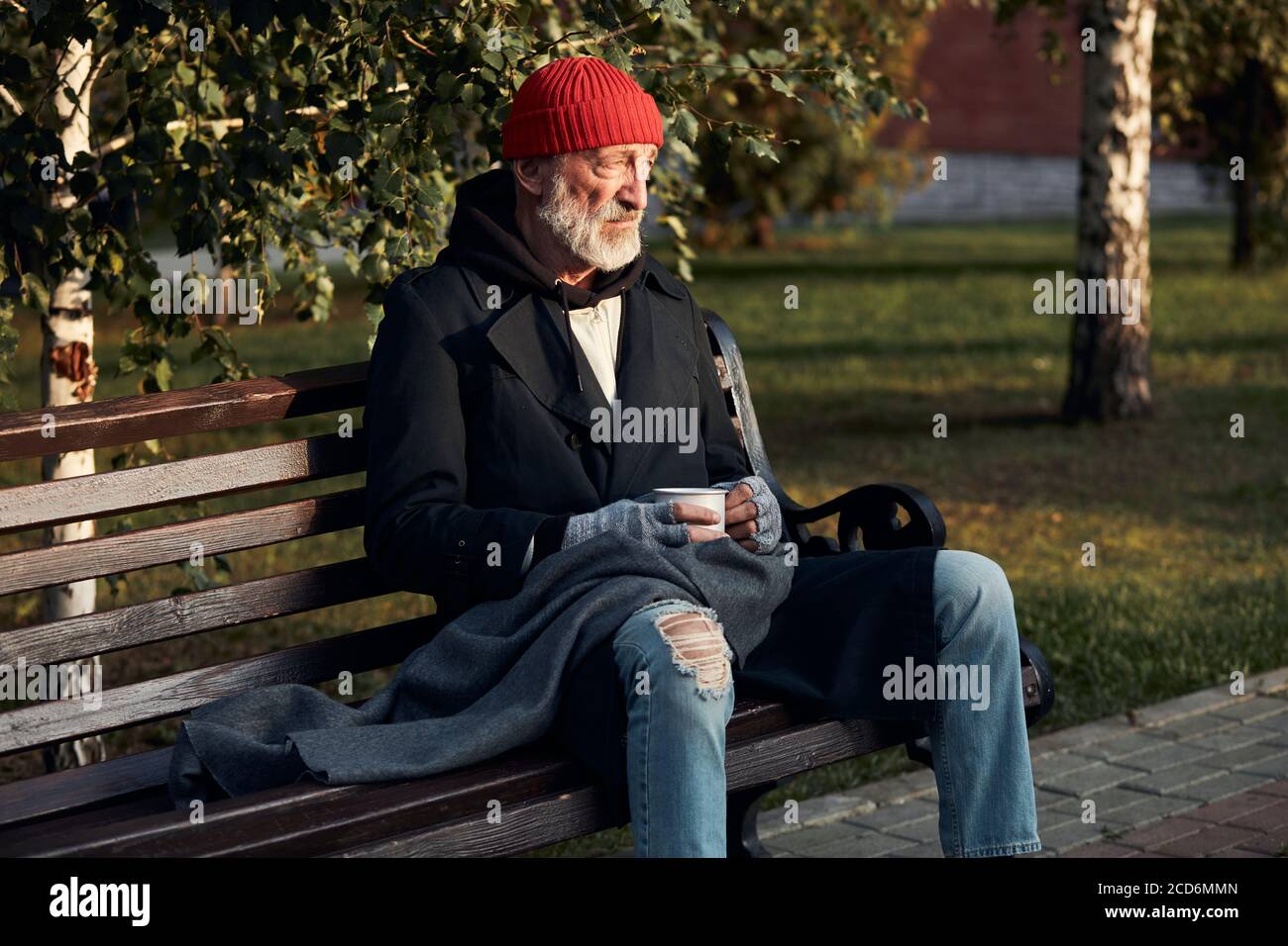 Senior beggar male desperately looking at empty street, looking forward ...