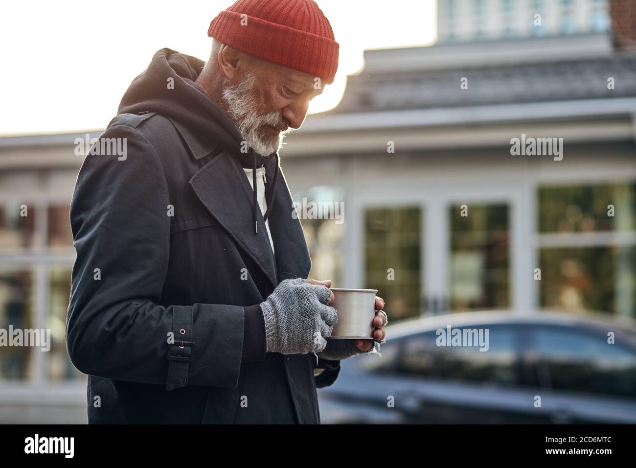 Penniless man collect money for shelter, food. Male desperately look at ...