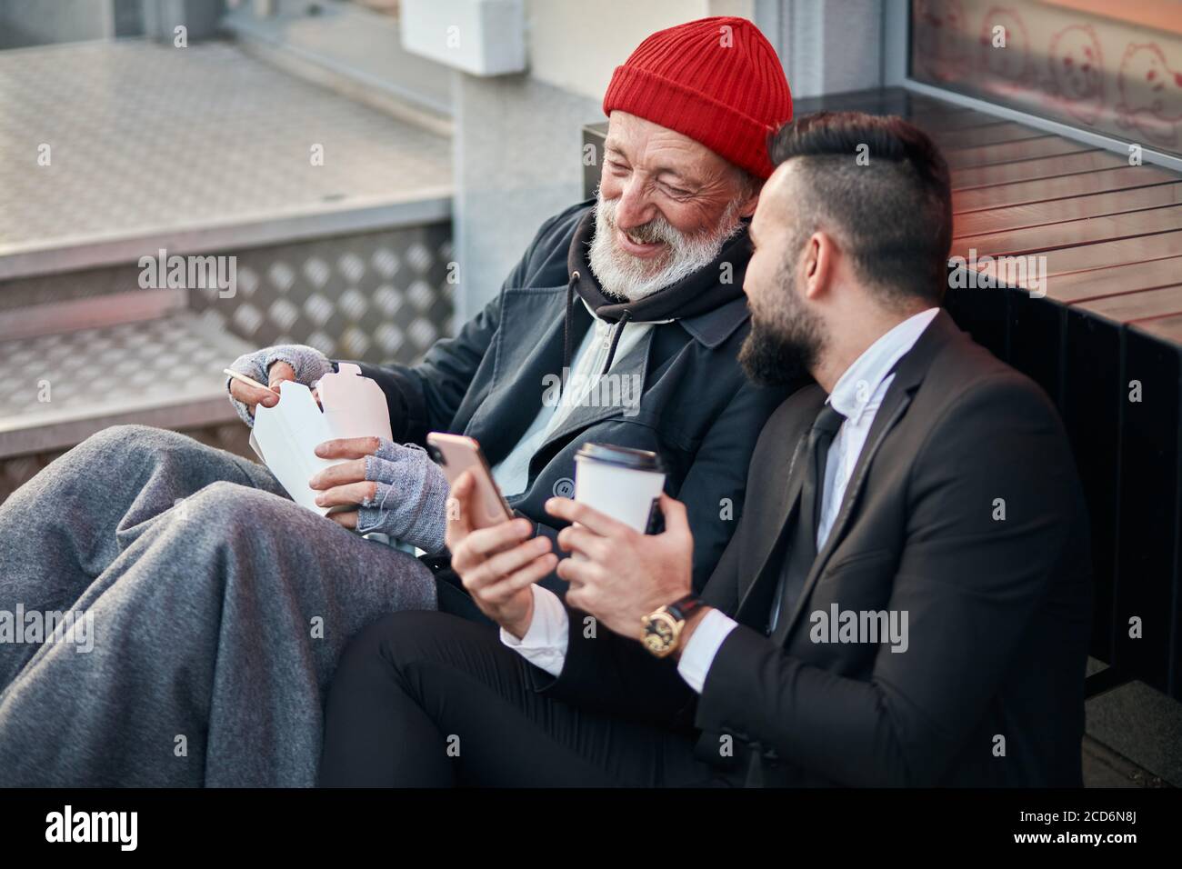 Happy rich male and poor male look at phone laughing, smile Stock Photo ...