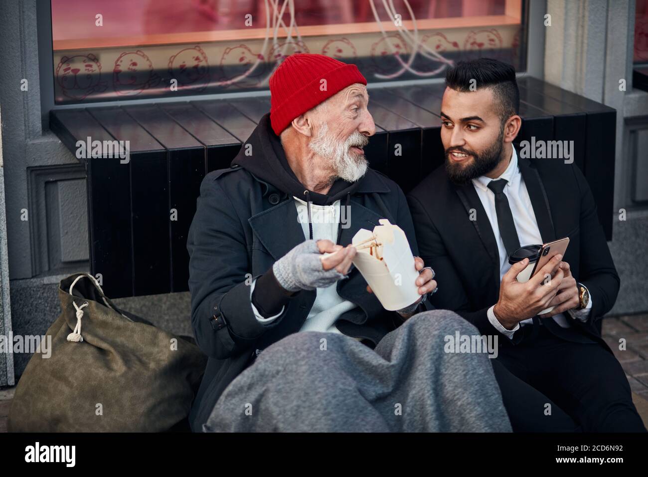 Rich man in black suit sit with phone, show interesting videos while ...