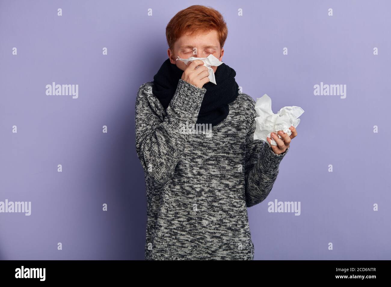 ill guy suffers from cold . close up portrait, isolated blue background ...