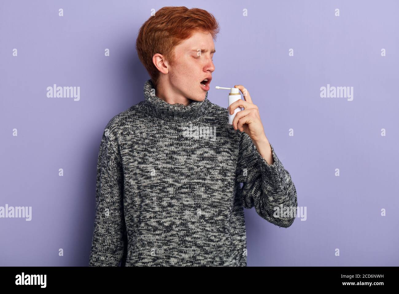man with closed eyes using sore throat spray, guy suffers from angina ...