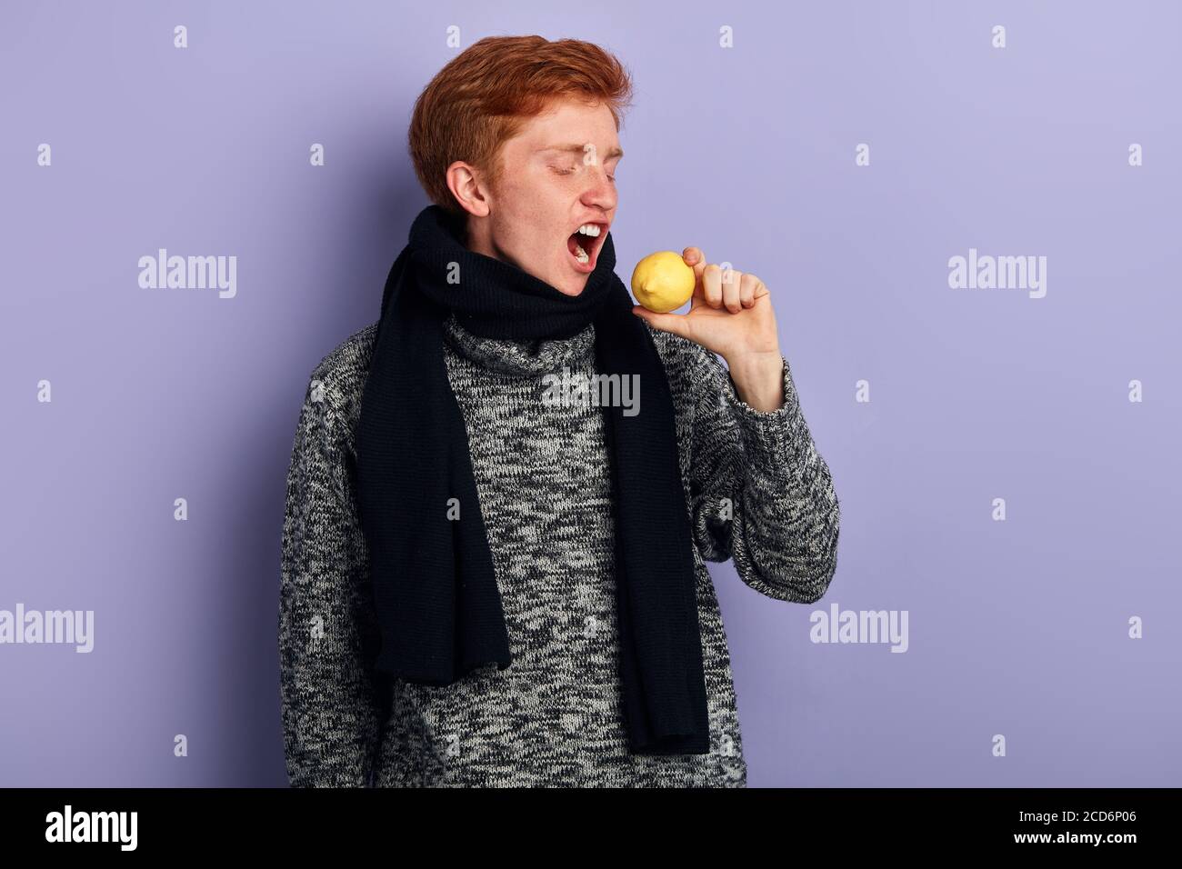 young man eating a lemon , he wants to recover from illness, secret of ...