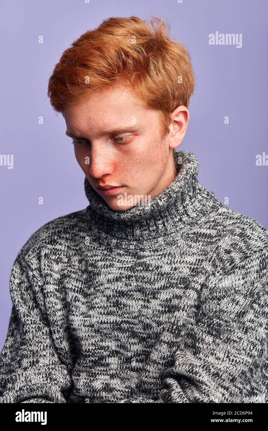 sad unhappy depressed young man in fashion sweater looking down ...