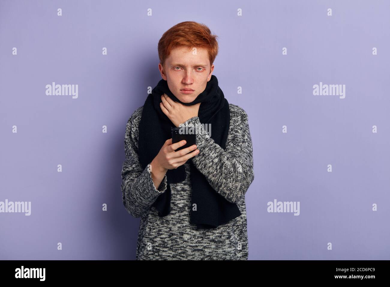 sick guy has lost his voice, he is using a smart phone, making a phone ...