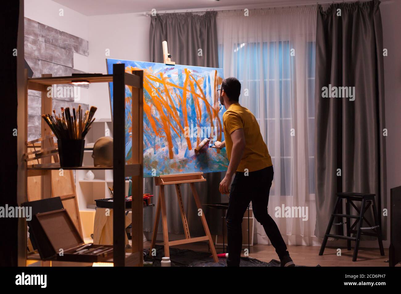 Successful painter in art workshop creating a masterpiece. Modern ...