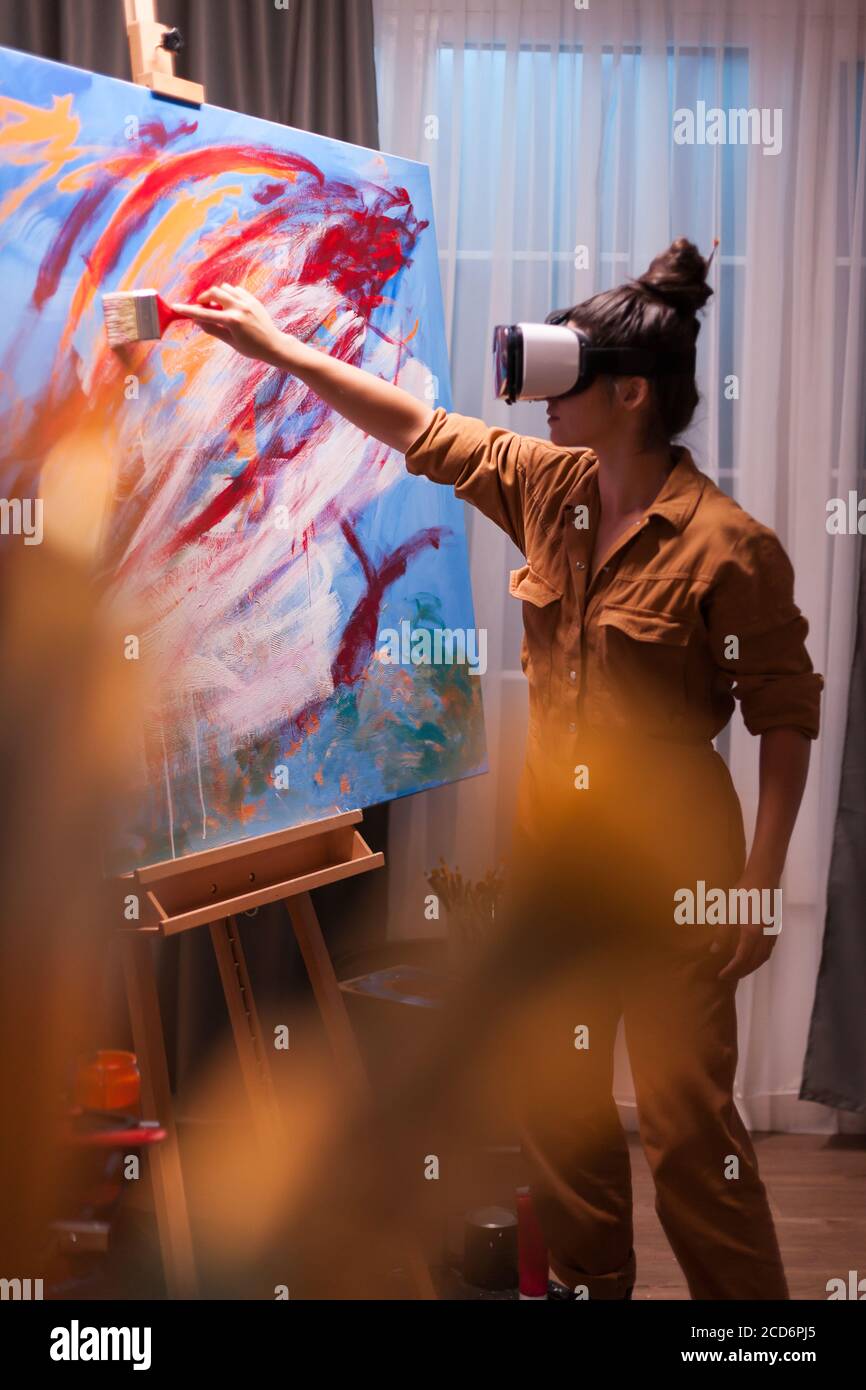 Painter using virtual reality headset and creating a masterpiece on ...