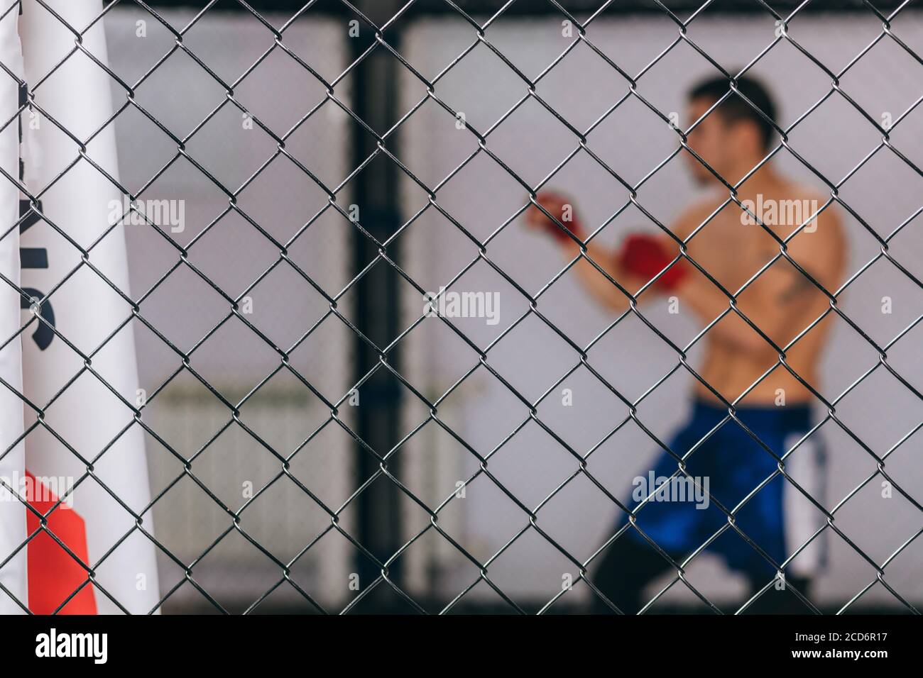 Focused male boxer showing determination and endurance exercising ...