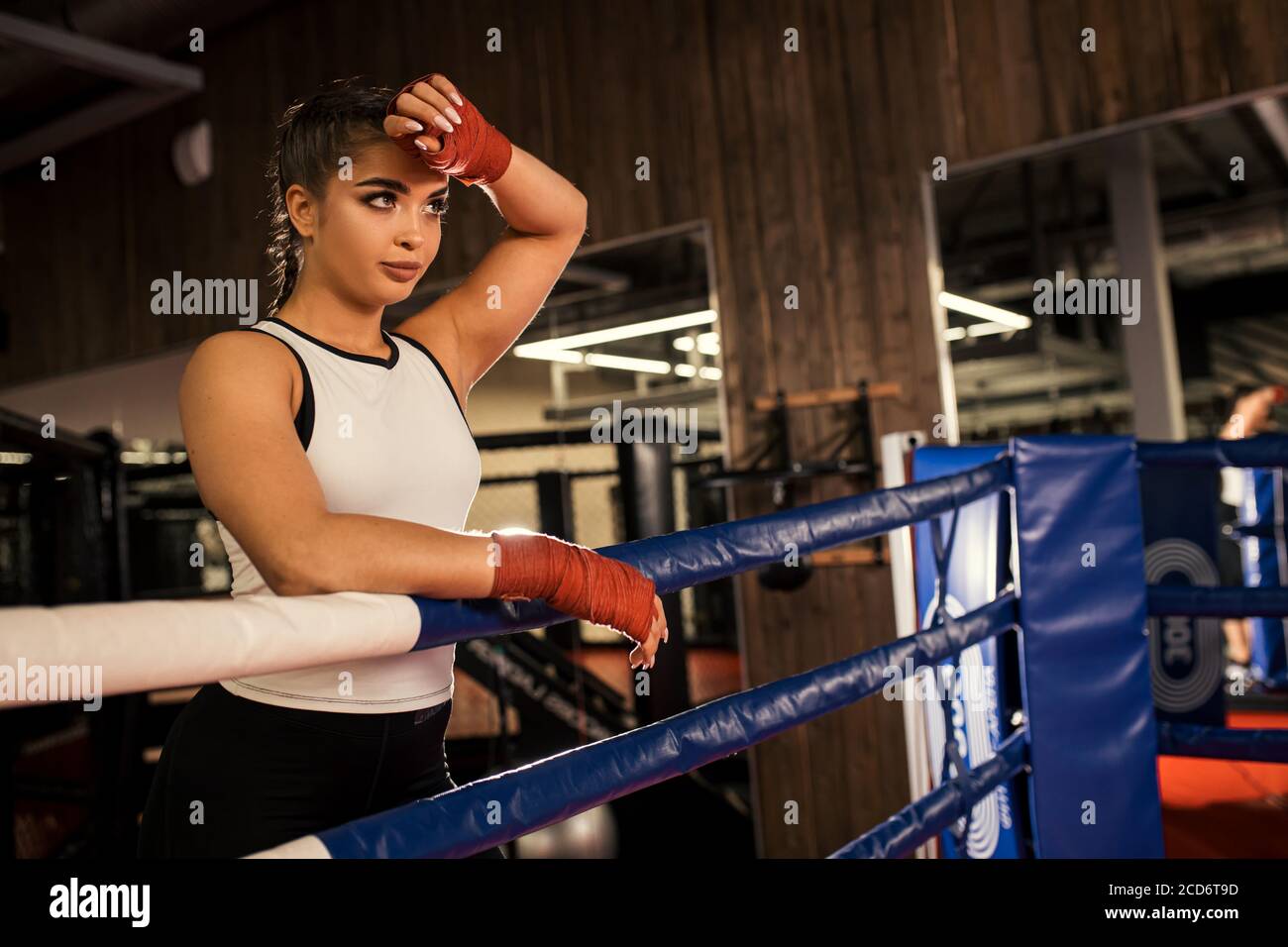 active young caucasian brunette woman boxer tired after fight with ...