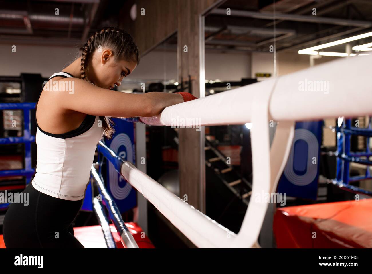 active young caucasian brunette woman boxer tired after fight with ...