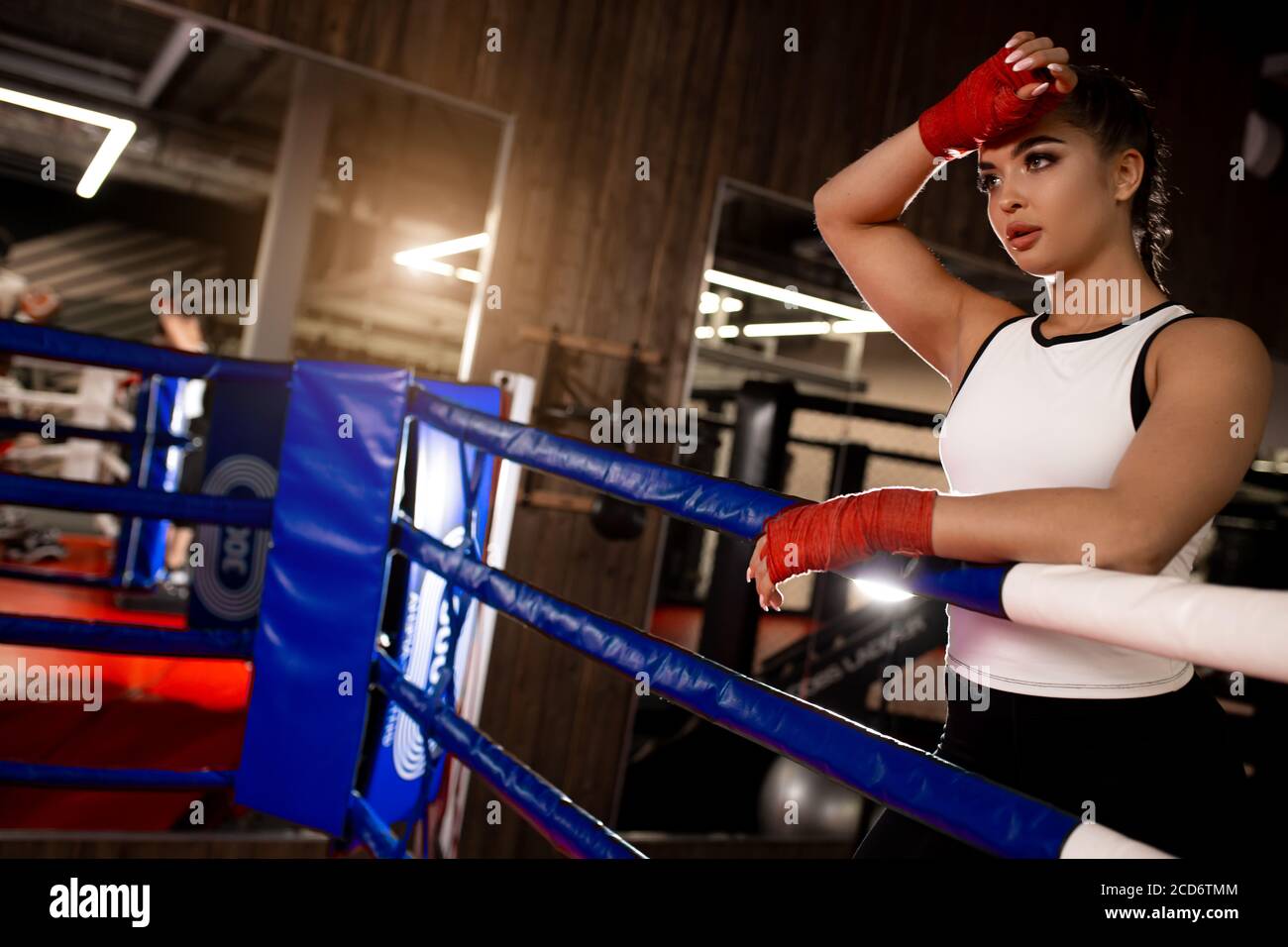 weary exhausted female boxer after intense effective training isolated ...