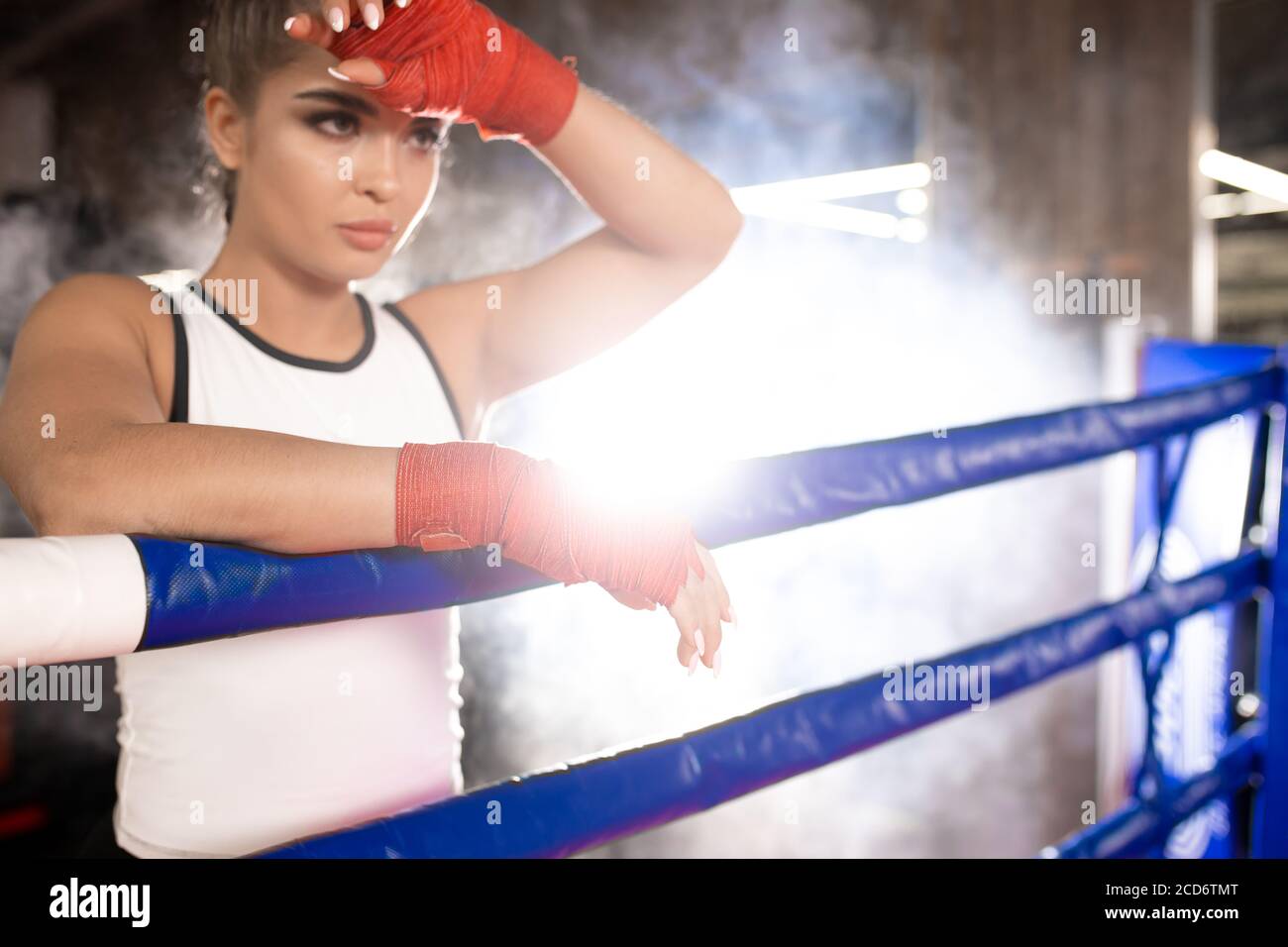 weary exhausted female boxer after intense effective training isolated ...