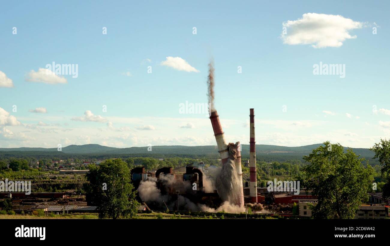 The collapse of an industrial chimney. Explosion of an old chimney of ...