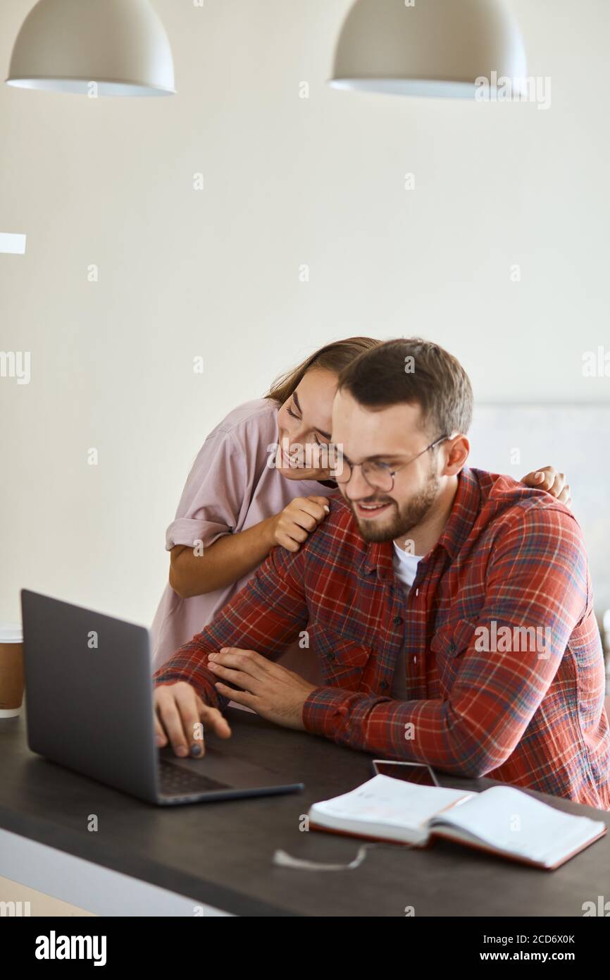Lovely beautiful girl casually dressed , puts head on wide shoulders of ...