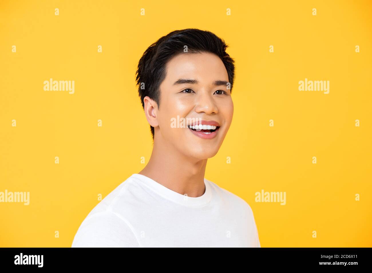 Close up portrait of young handsome Asian man cheerfuly smiling and ...
