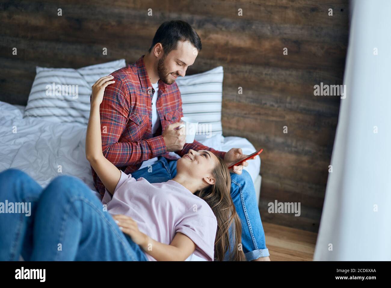 Woman lying on bed knees hi-res stock photography and images - Alamy