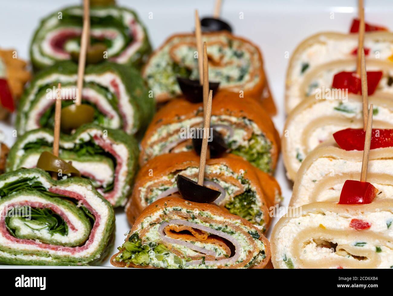 A variety of cold snacks on the table at parties, roulades with cheese ...