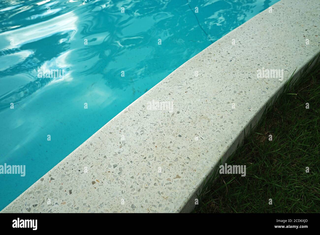 Marbled cement step between swimming pool and grassy ground Stock Photo ...