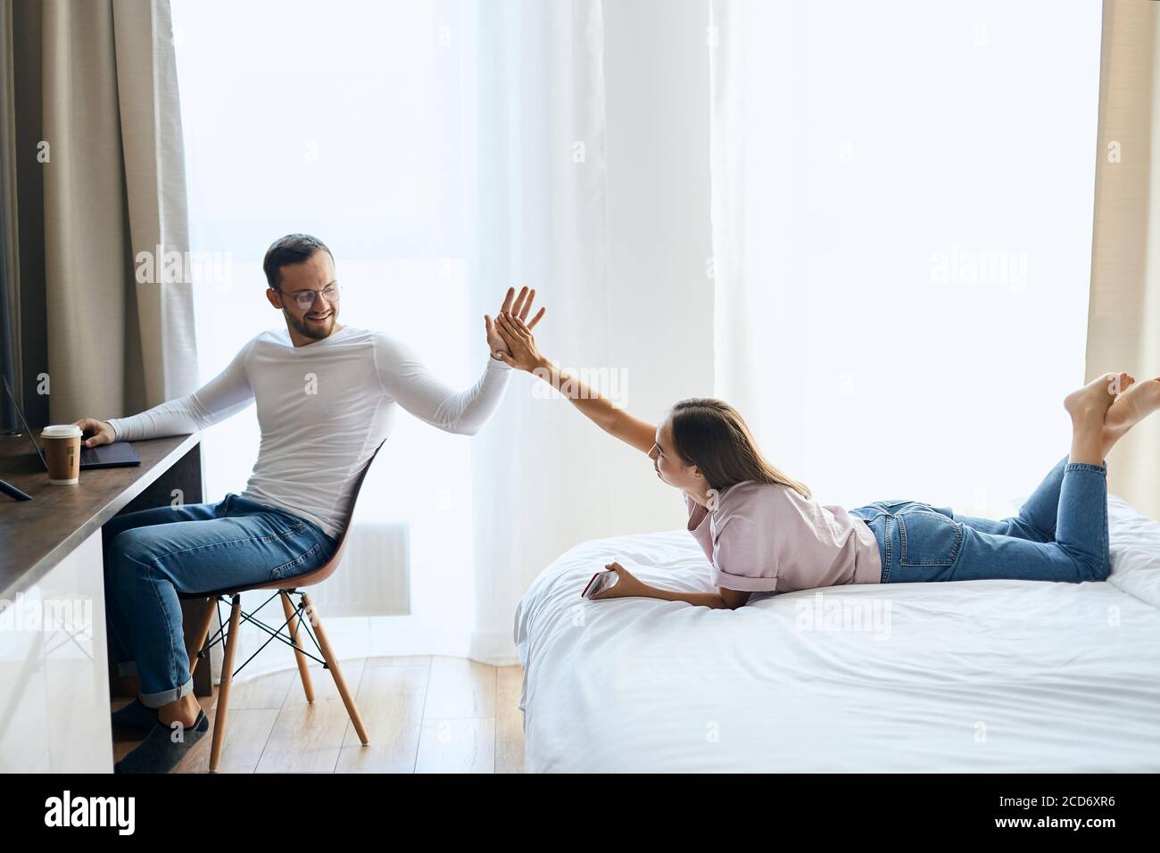 Young bearded man in optical glasses, working at laptop computer in ...