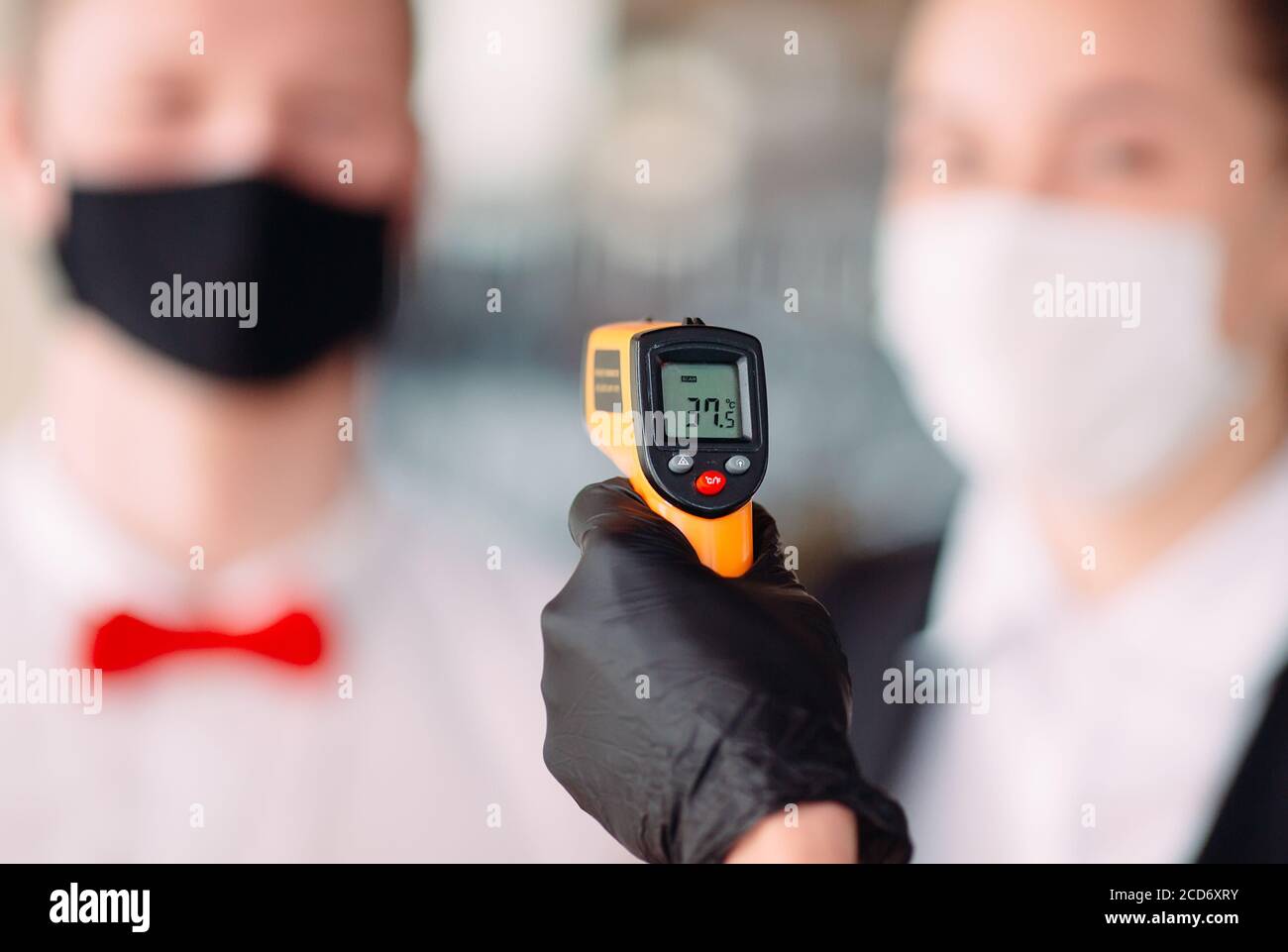 The Manager of a restaurant or hotel checks the body temperature of the ...