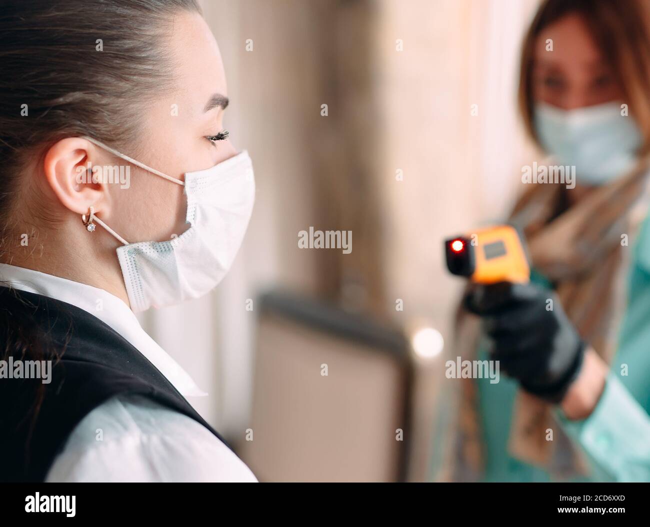 The Manager of a restaurant or hotel checks the body temperature of the ...