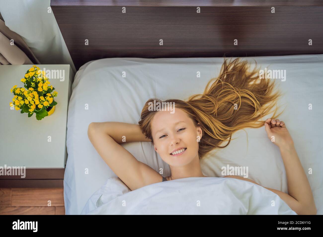 Sleep without a pillow. Young Woman Sleeping In Bed without a pillow ...